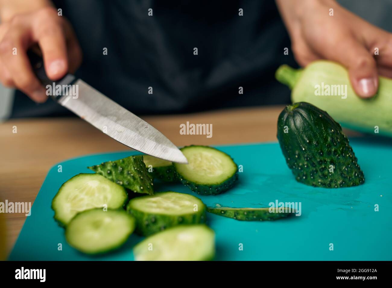 Cook on the kitchen cutting vegetables isolated background Stock Photo ...