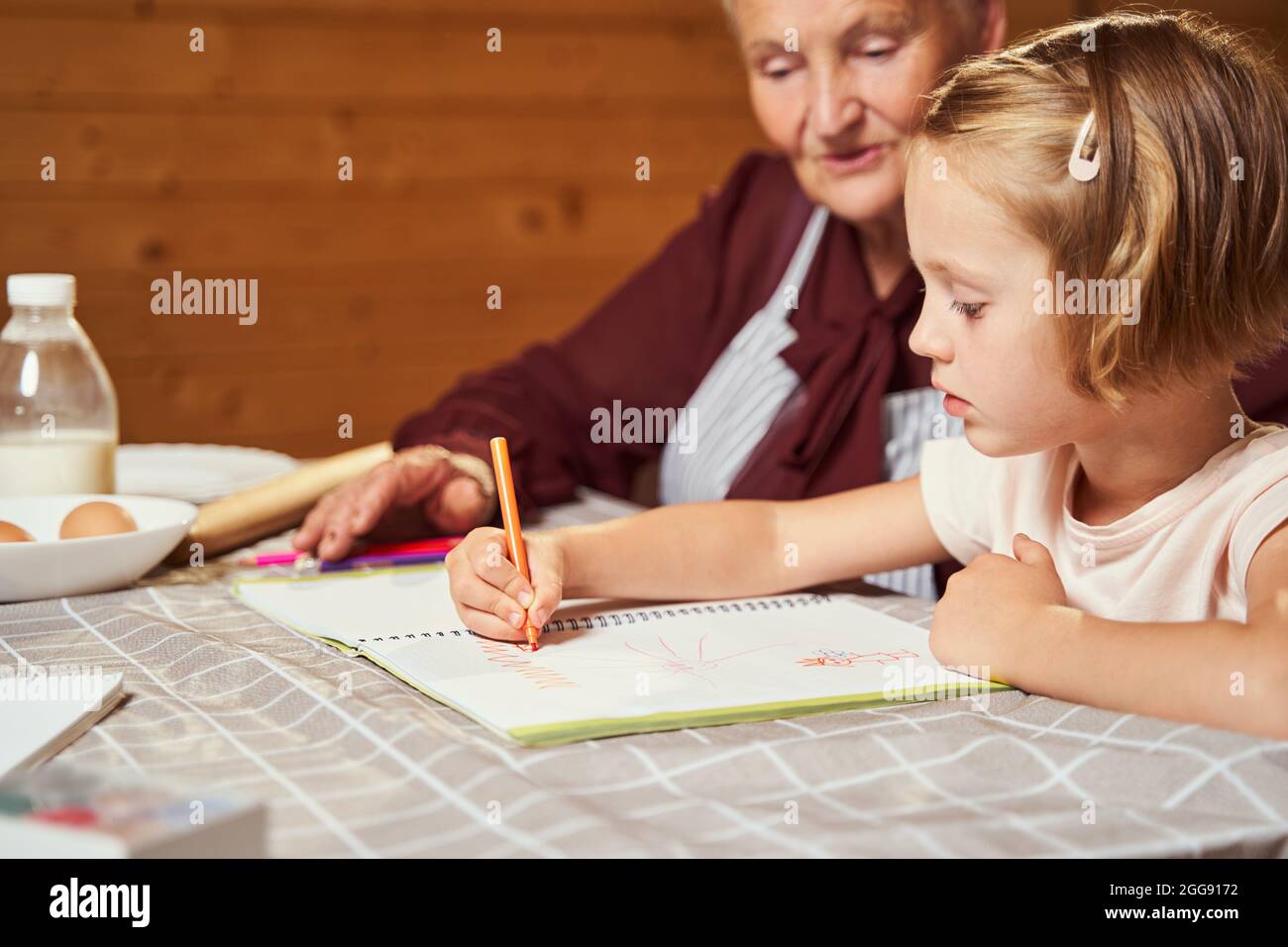 Diligent girl drawing in notebook with coloured felt-tip pen Stock ...