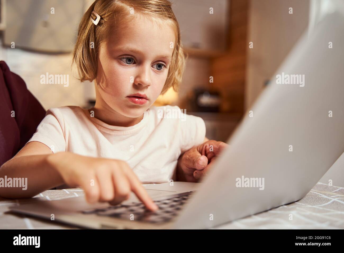 Focused child pressing one button on laptop keyboard Stock Photo - Alamy