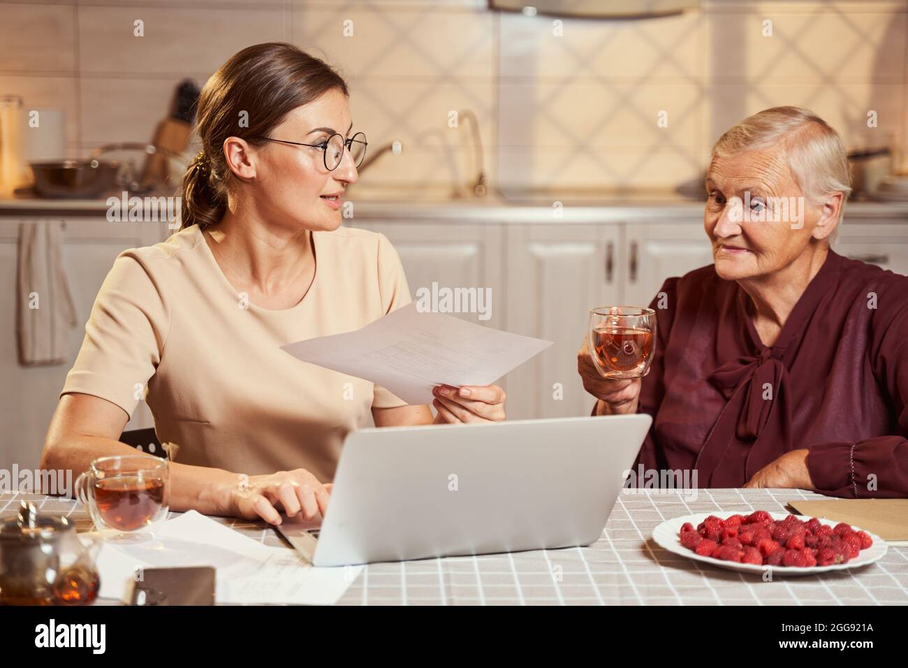 Confused worker with document turning for advice to elderly person ...