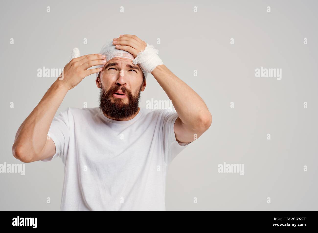 Man bandaged head and hand blood treatment Stock Photo - Alamy