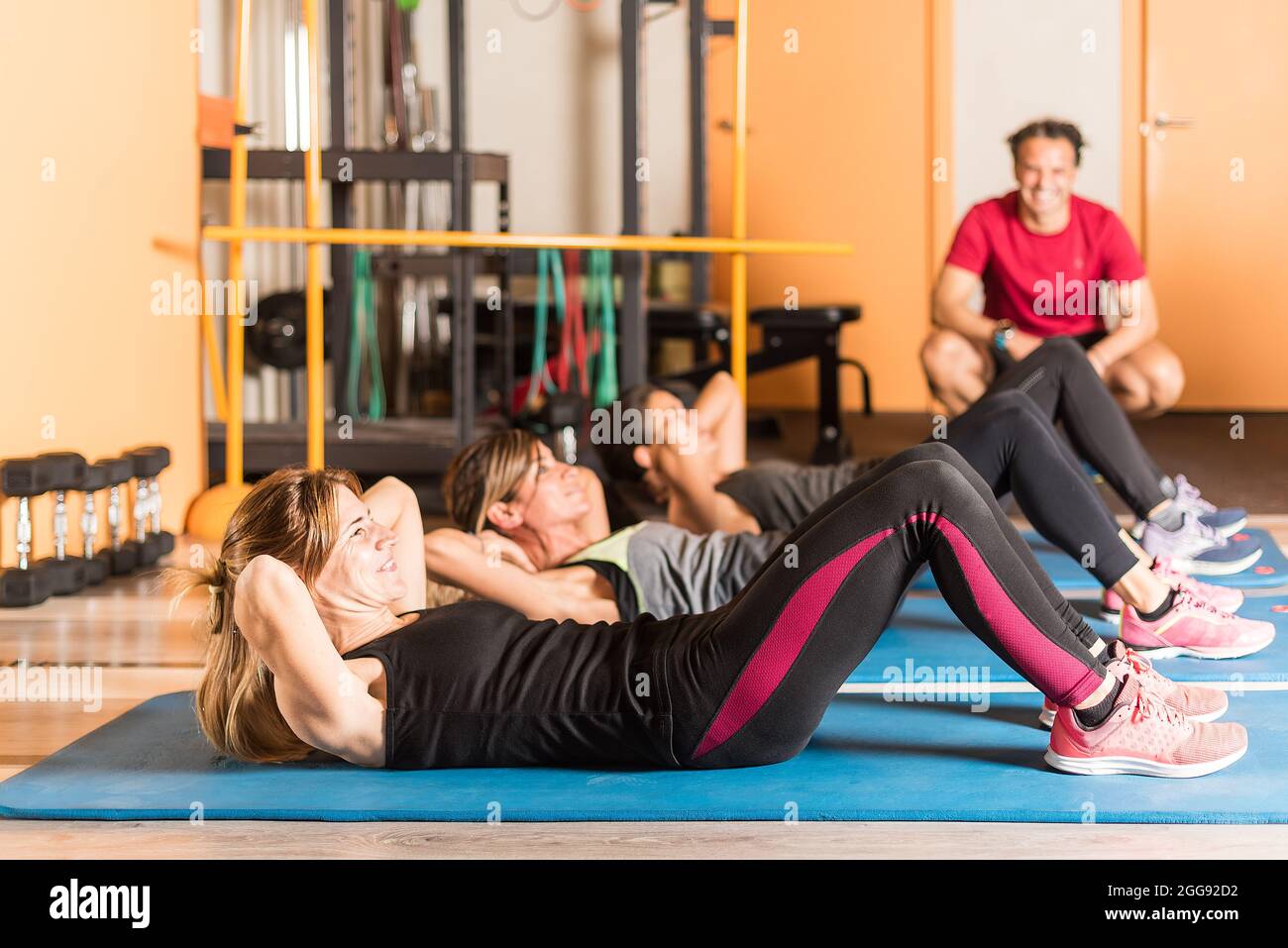 Side view of Athlete women doing abs exercise in gym Stock Photo - Alamy
