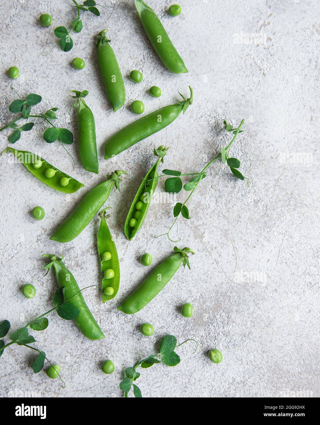Fresh green peas pods and green peas with sprouts on concrete ...