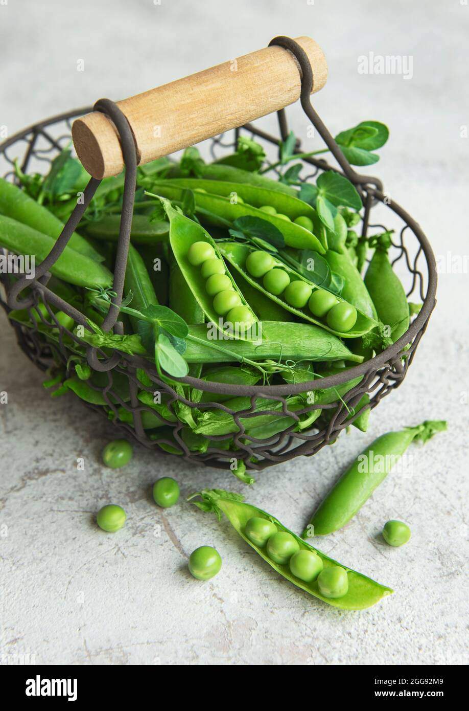 Fresh green peas pods and green peas with sprouts on concrete ...
