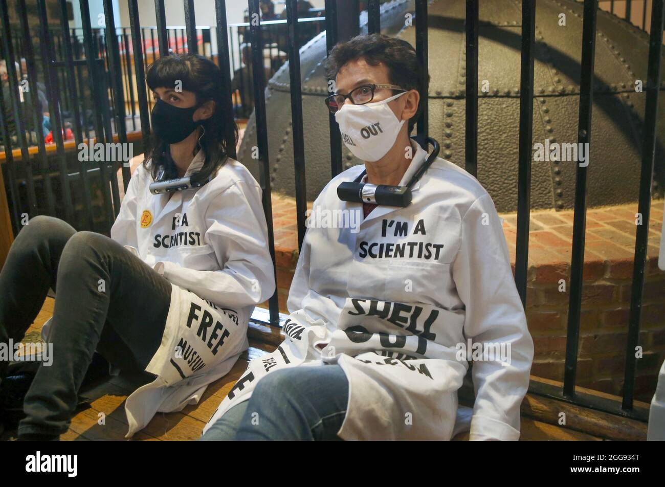 Protesters lock themselves onto railings inside the science museum ...