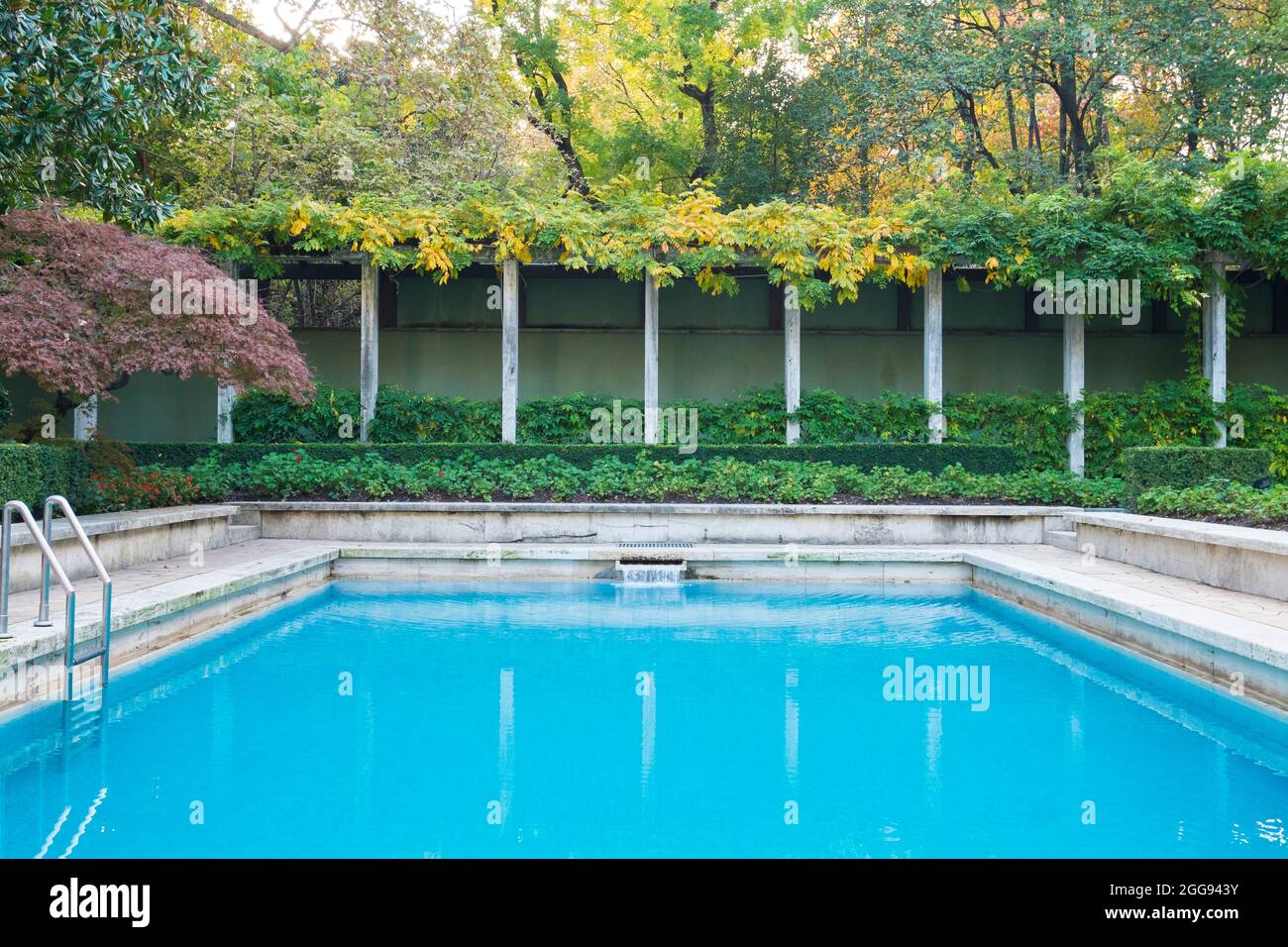 The blue swimming pool with garden portico, arbor, trellis. At the ...