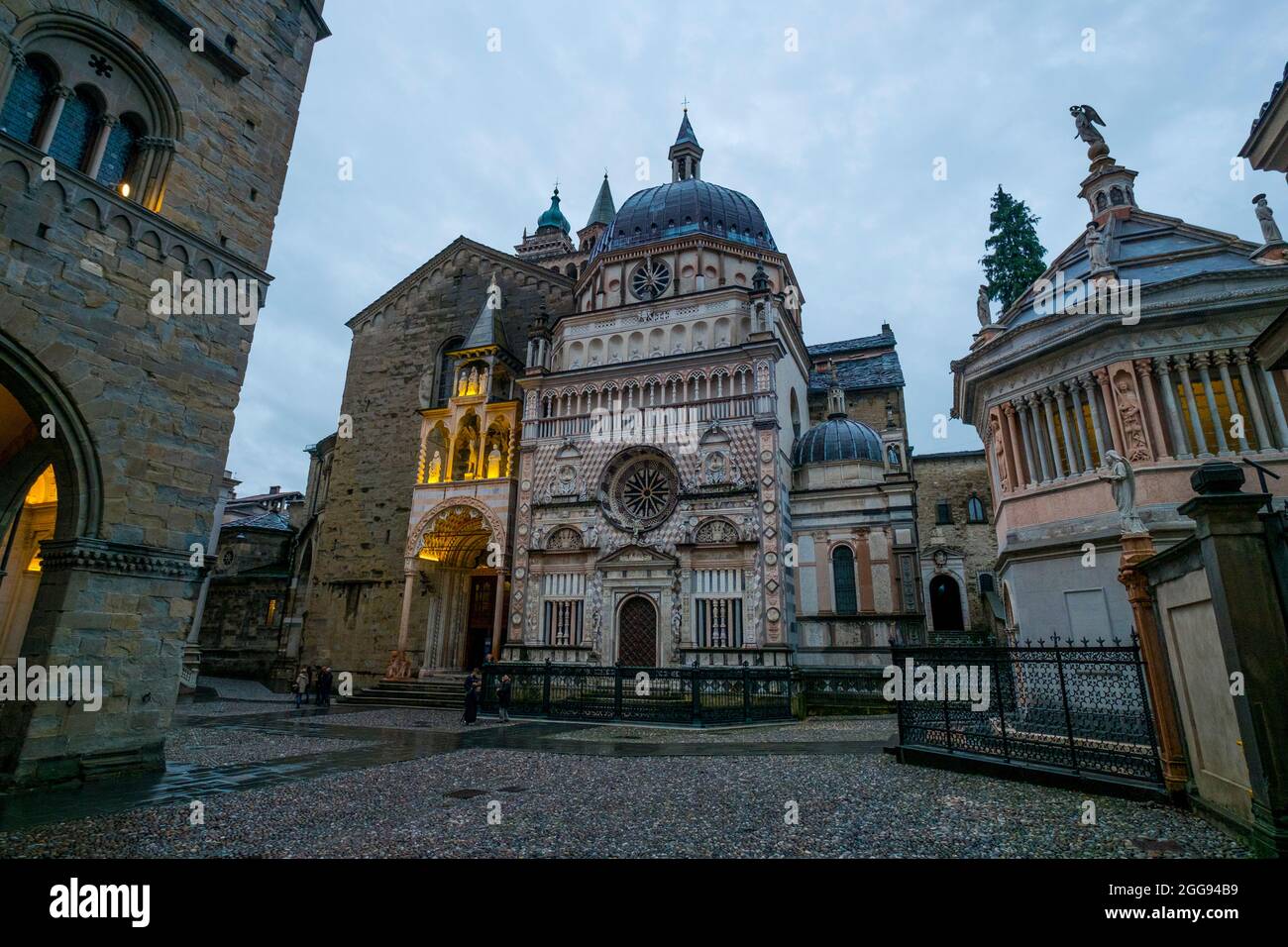 The Catholic church facade of Cappella Colleoni, at dusk on a wet ...