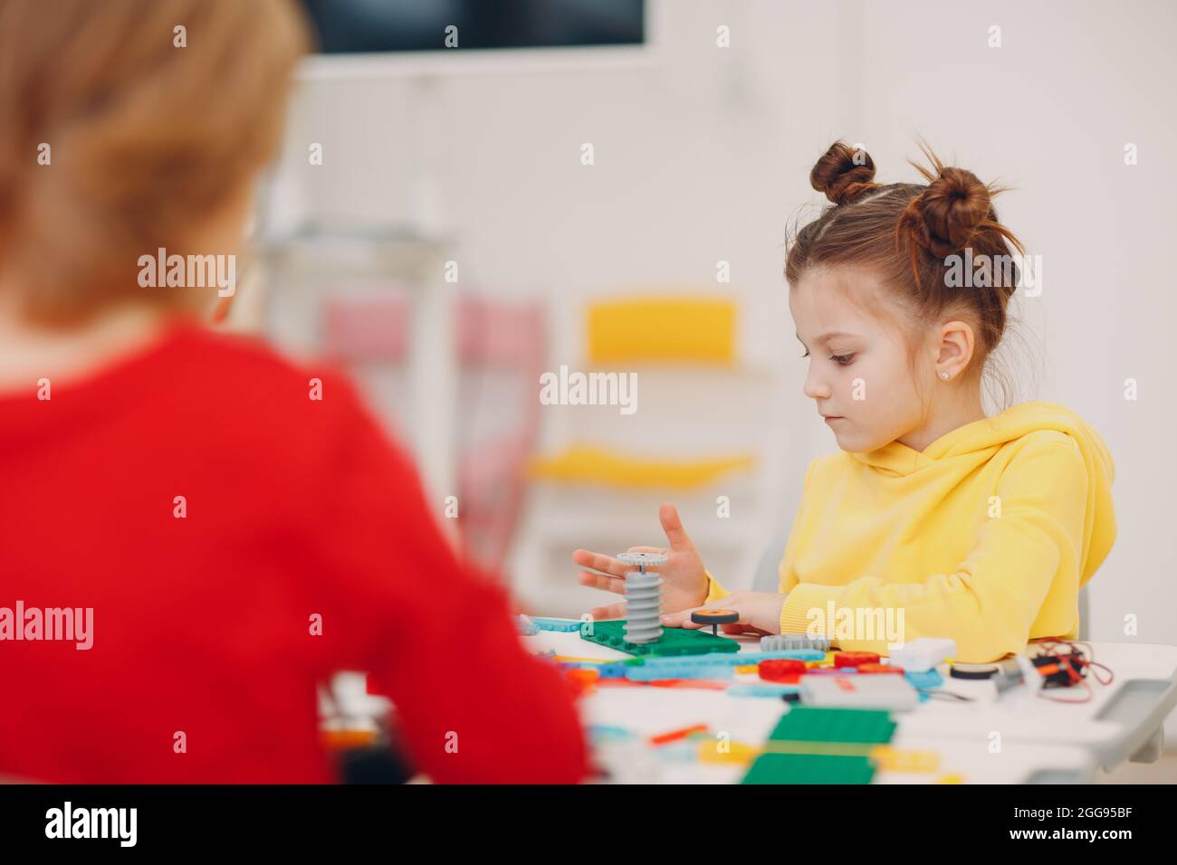 Smiling kid child constructor checking technical toy. Children Robotics ...