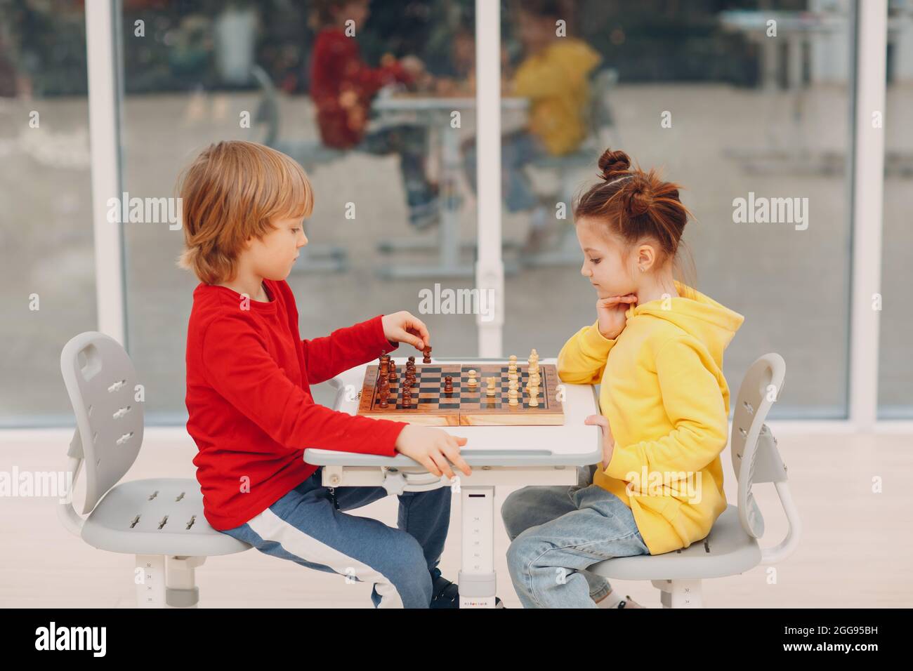 Little kids playing chess at kindergarten or elementary school Stock ...