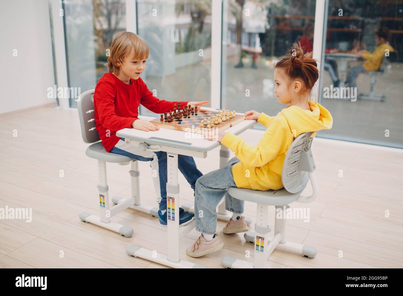 Little kids playing chess at kindergarten or elementary school Stock ...