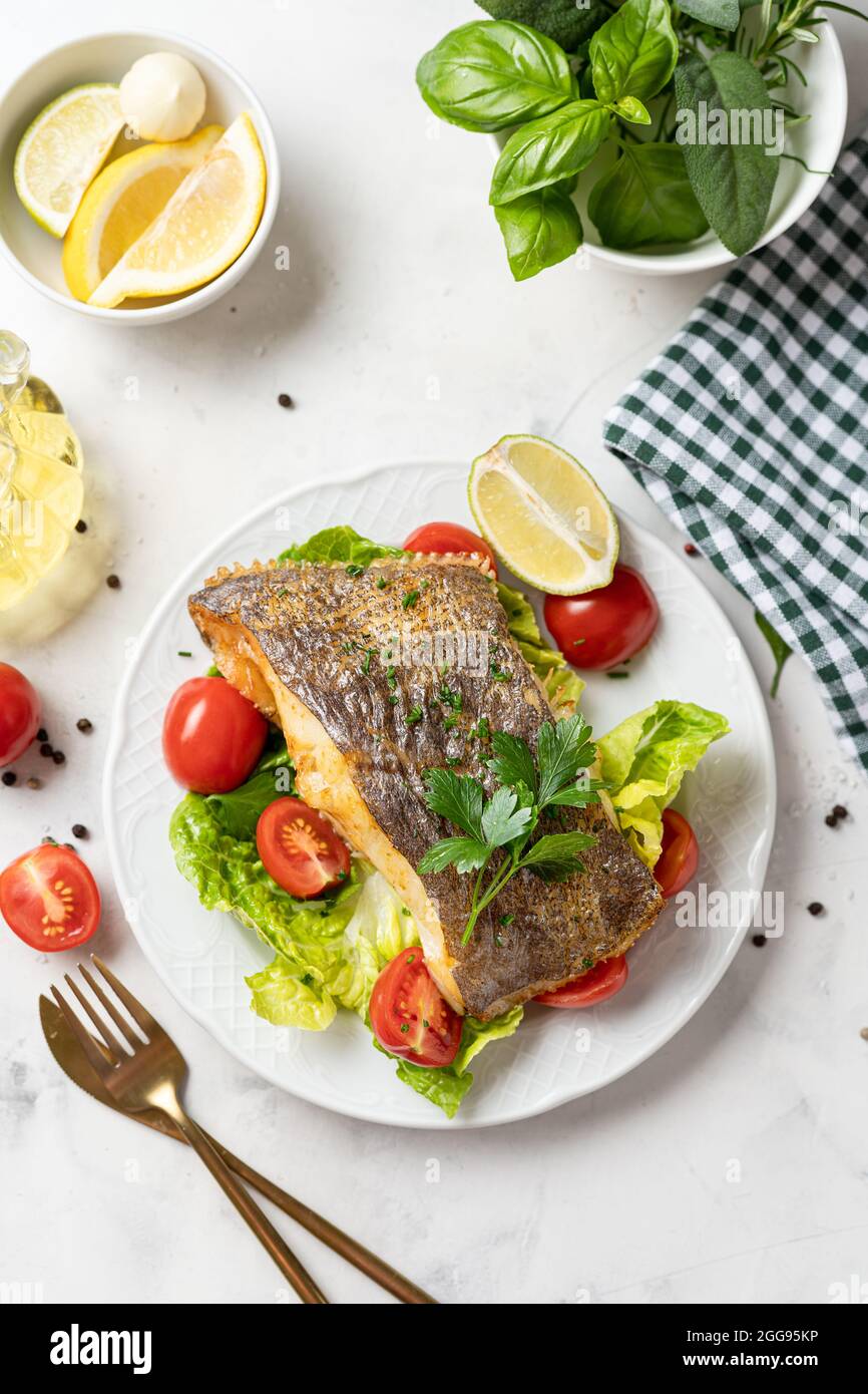 Top view of prepared delicious halibut fish steak with salad Stock ...