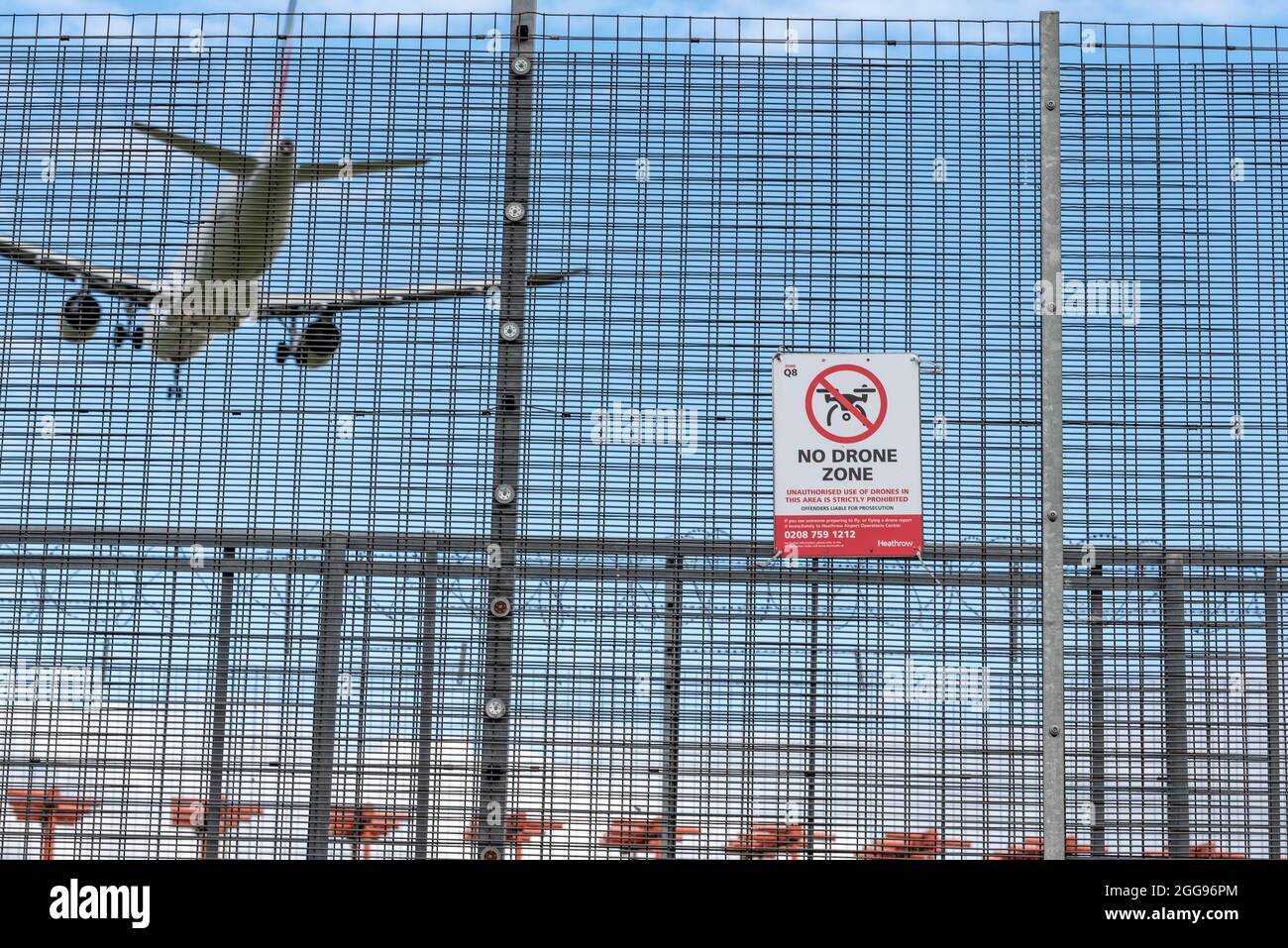 No drone zone sign at London Heathrow Airport, UK, with airliner plane ...