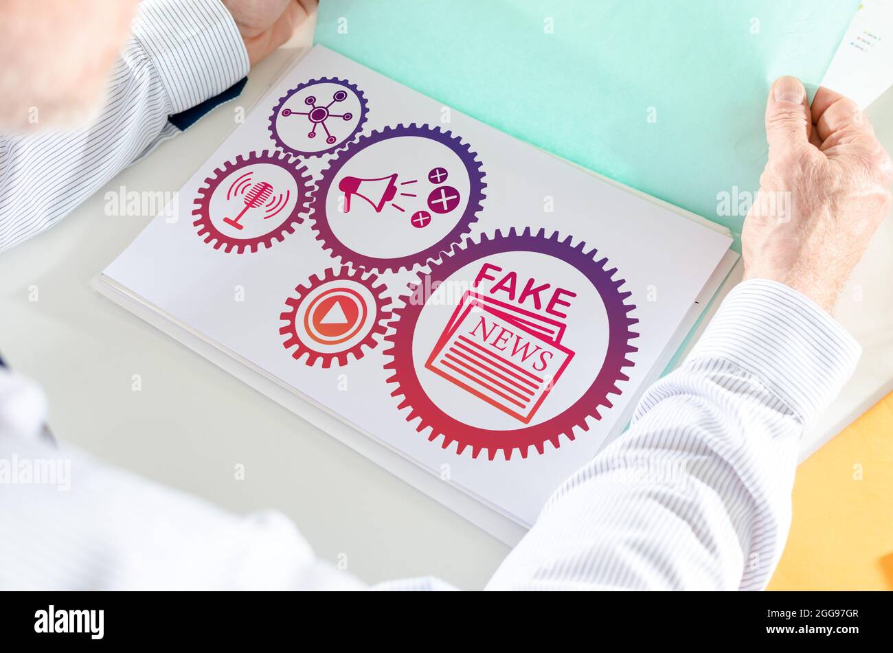 Man holding a file with fake news concept Stock Photo - Alamy
