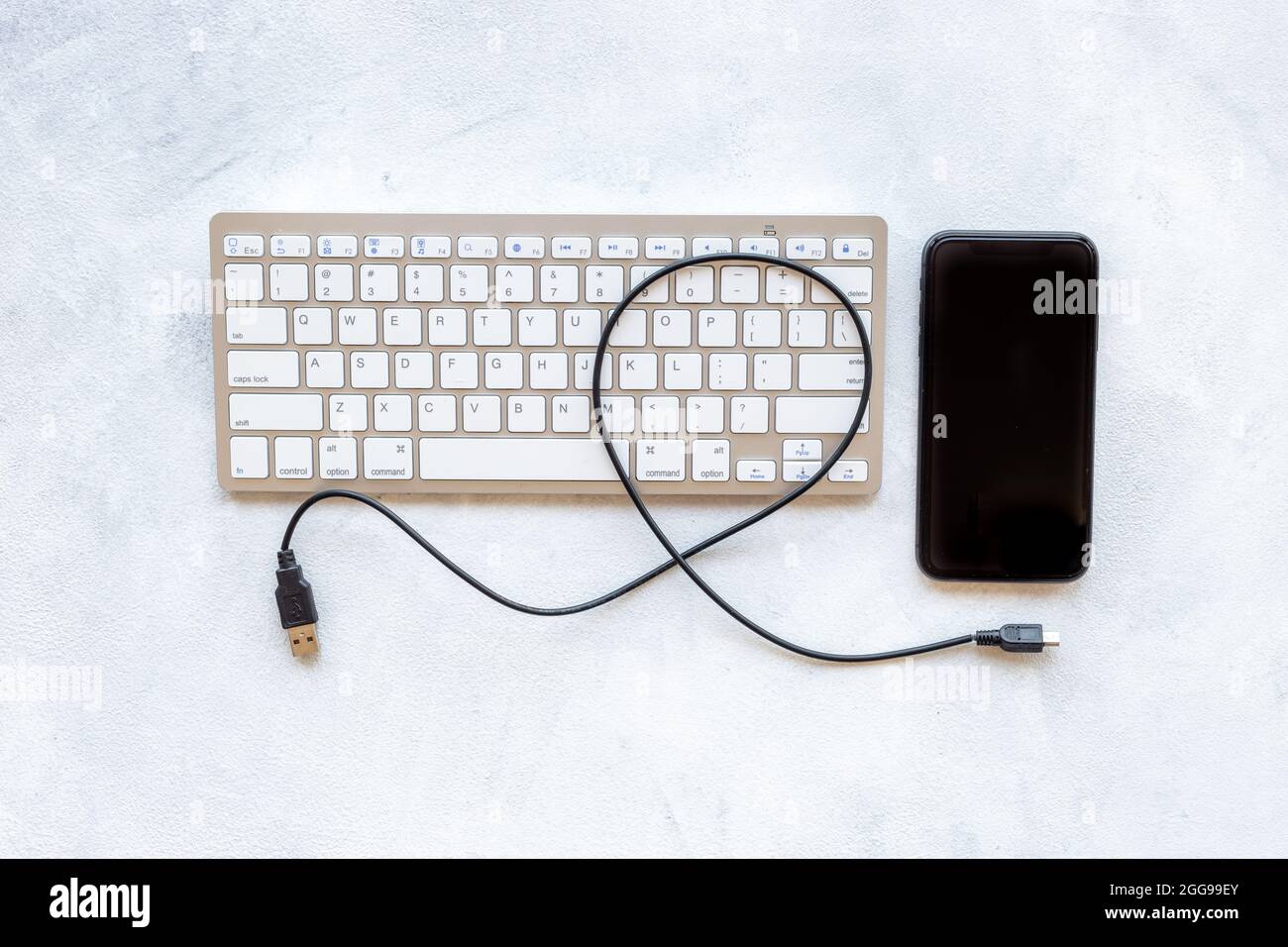 Usb cable for charging mobile phone and computer on office table Stock ...