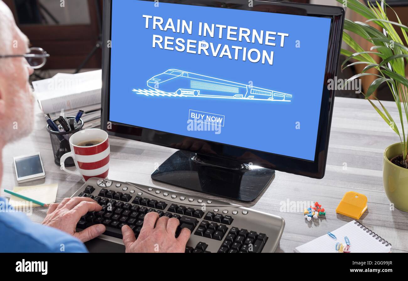Man using a computer with train internet reservation concept on the ...