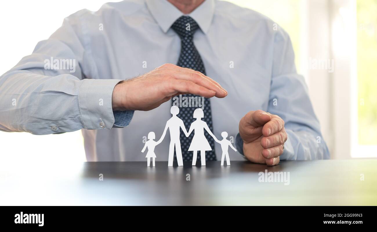 Insurer protecting a family with his hands Stock Photo - Alamy