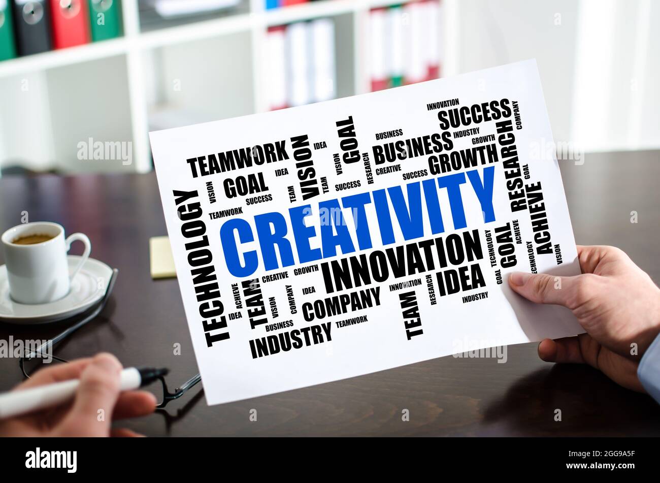 Hand holding a paper showing creativity word cloud concept Stock Photo ...