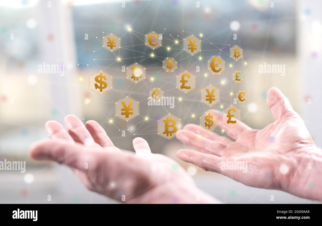 Currency exchange concept above the hands of a man Stock Photo - Alamy