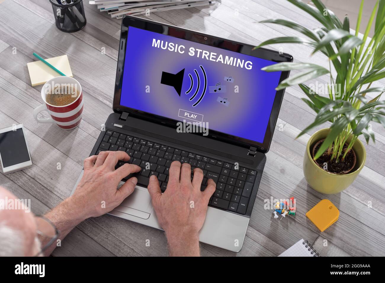 Man using a laptop with music streaming concept on the screen Stock ...