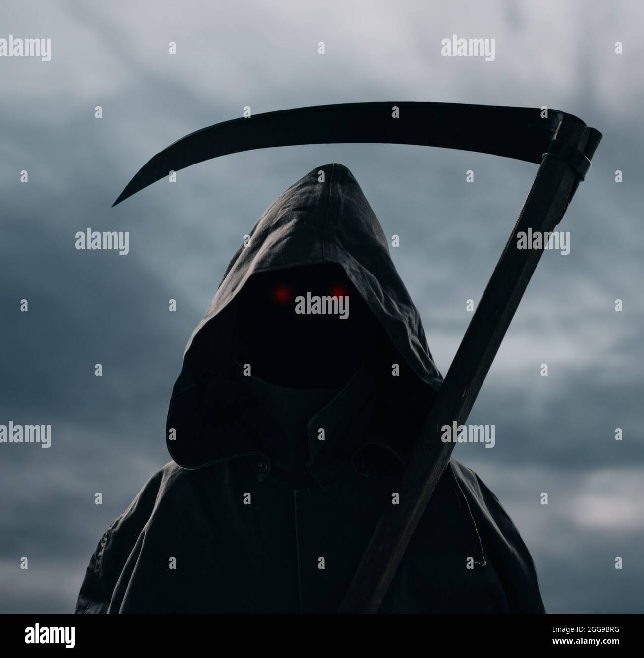 Death with a scythe stands against the background of a dark sky Stock ...