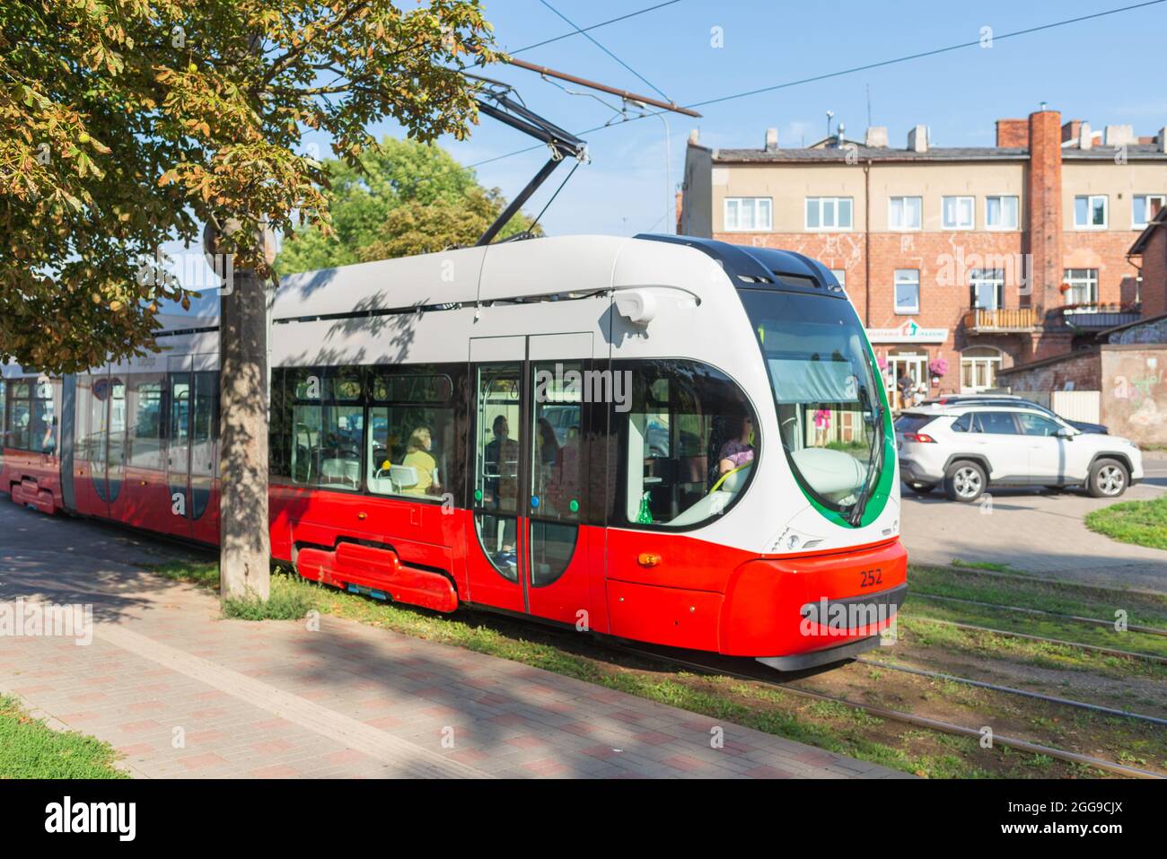 Traditional old tram in the Town. Red and white tram in a city ...