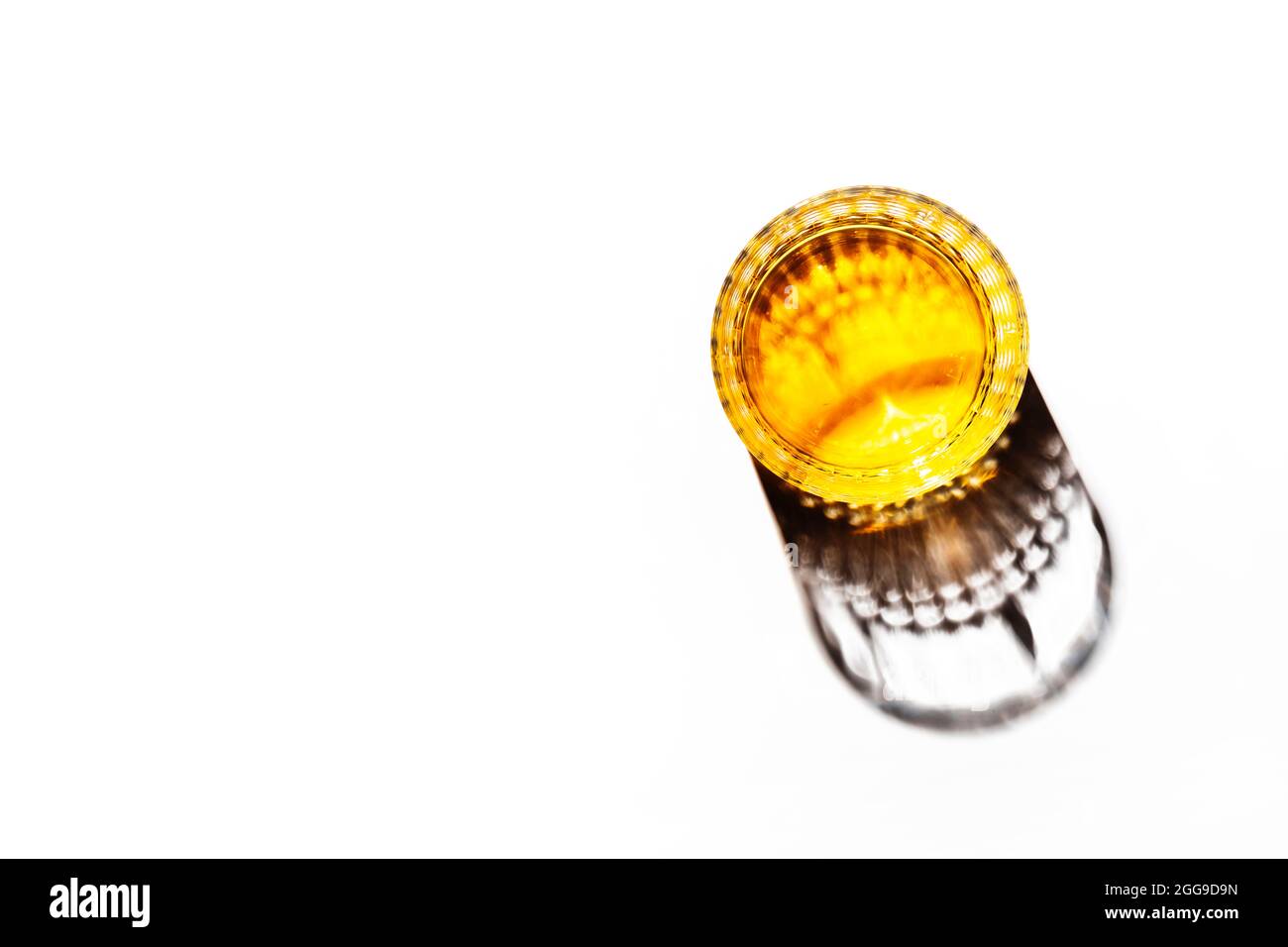 American bourbon whiskey in glass, white background with shadow pattern ...