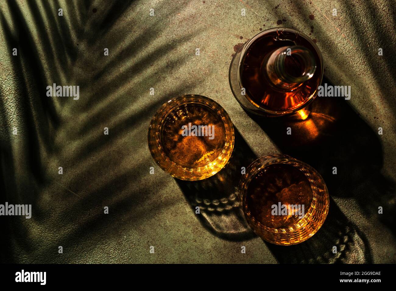 American bourbon whiskey in glasses and bottle, rusty green background ...