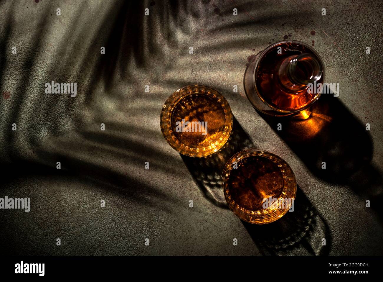 American bourbon whiskey in glasses and bottle, rusty green background ...