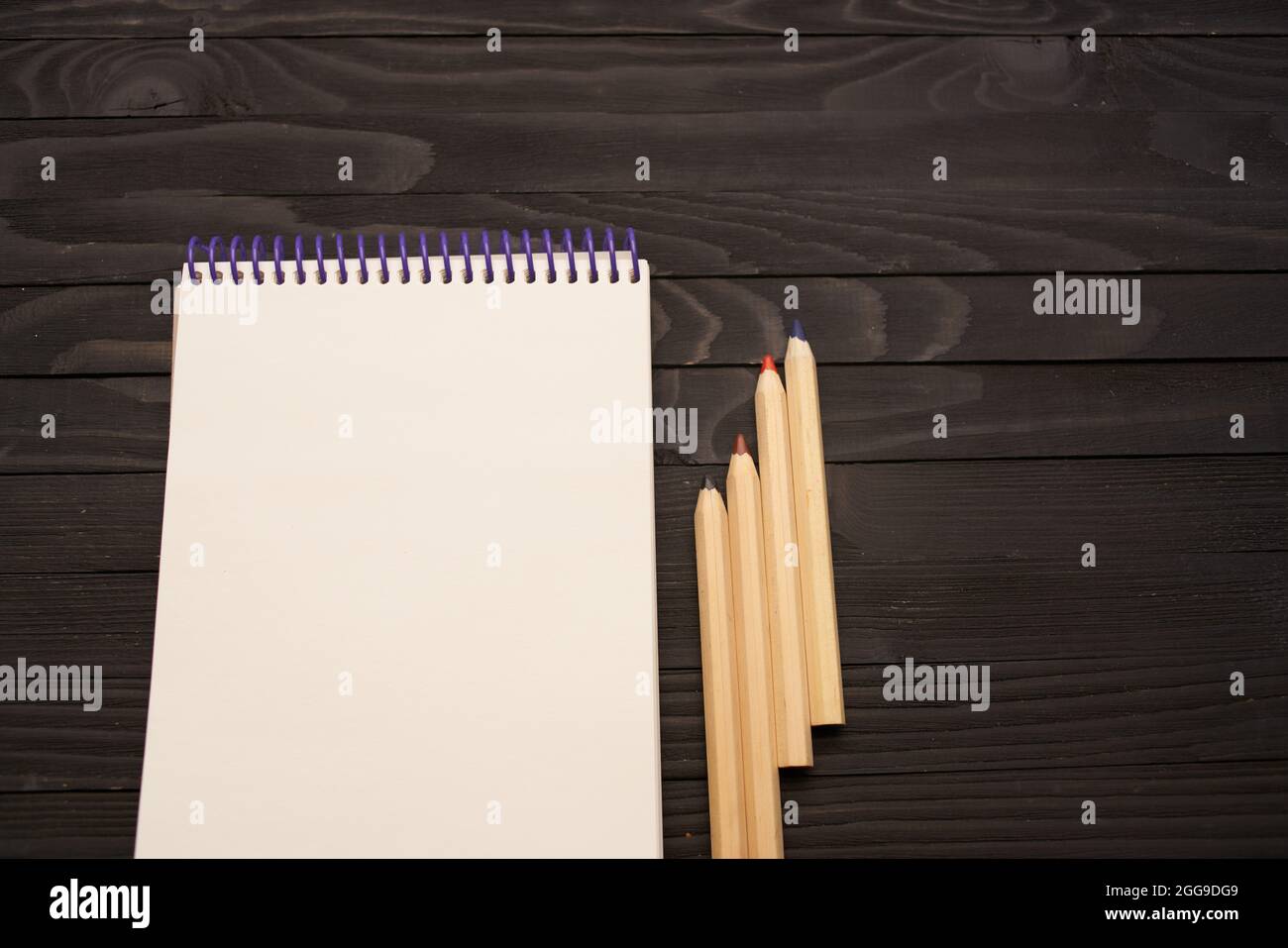 notebook pencils wooden table tools for artists Stock Photo - Alamy