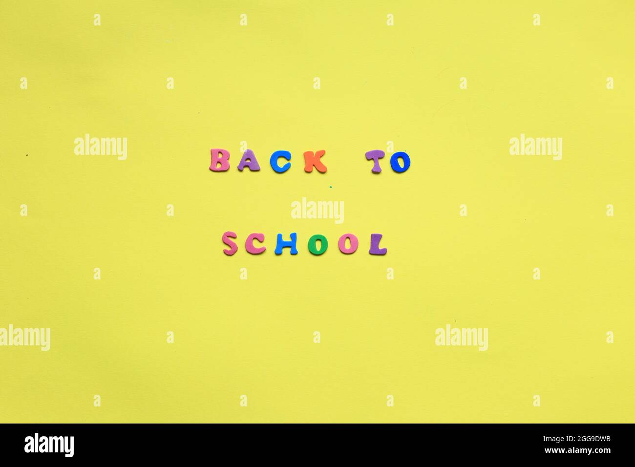 Words from multi colored letters on a yellow background. Expression ...