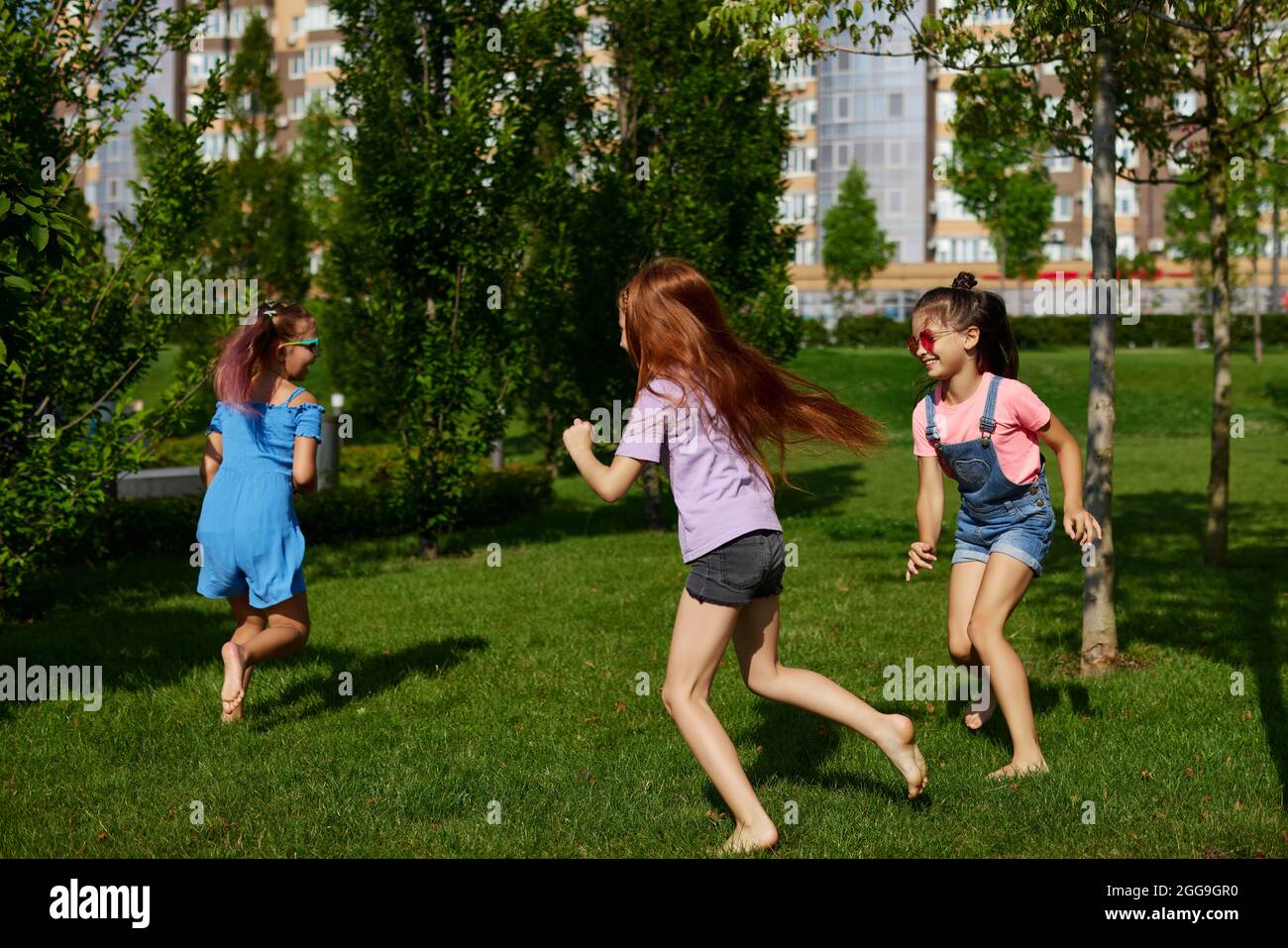 Happy children running together hi-res stock photography and images - Alamy