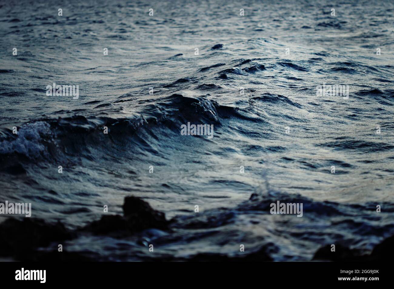 Dark deep blue sea water with waves in twilight, serene and calming ...
