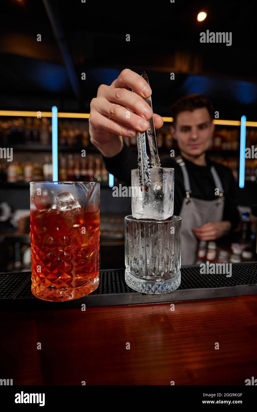 Barman putting ice glass hi-res stock photography and images - Alamy