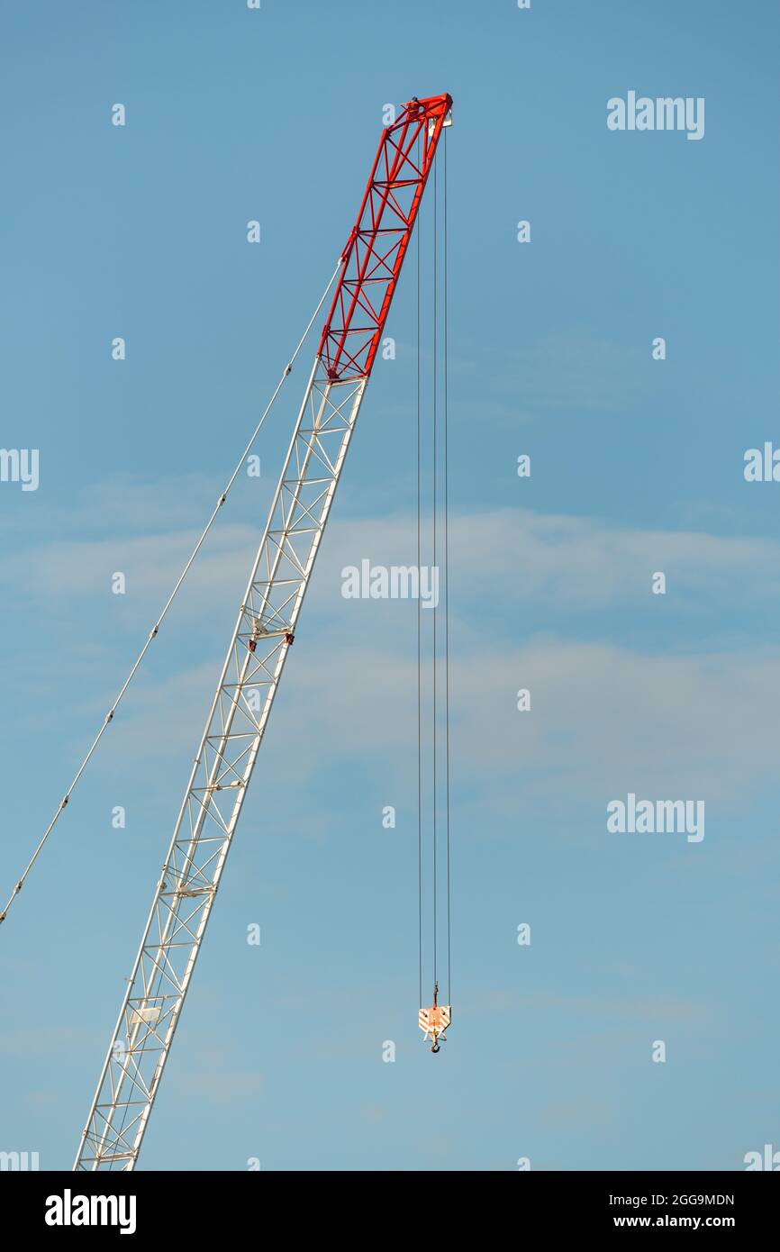 Industrial construction crane against the blue sky. Vertical format ...