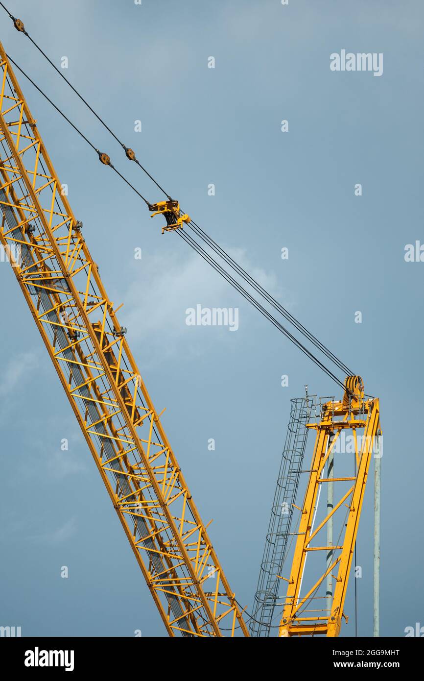 Industrial construction crane against the moody sky. Vertical format ...