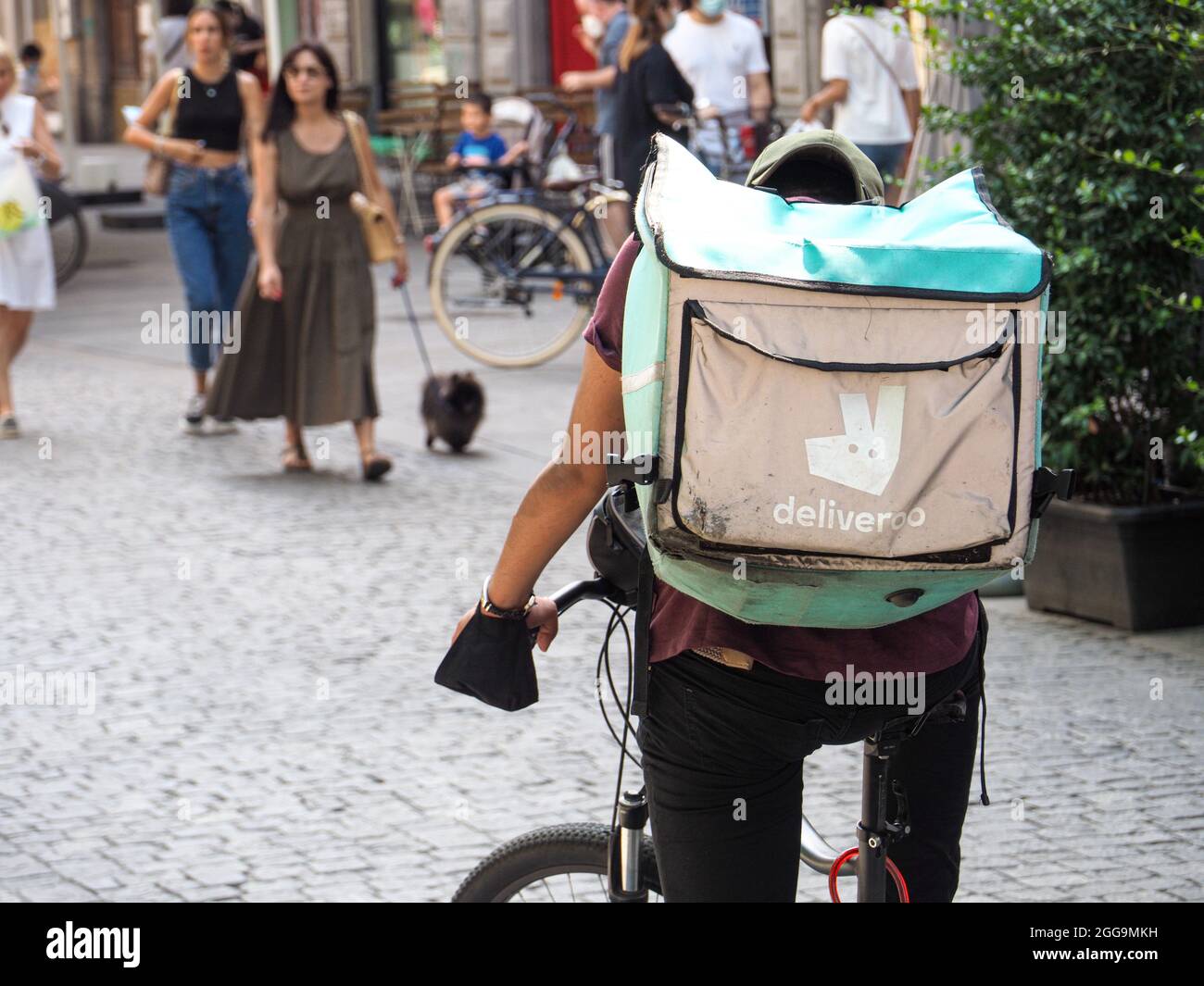 MILAN, ITALY - Aug 08, 2021: A rear view of a rider delivering food ...
