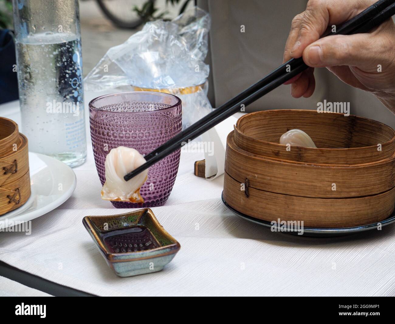 Hand with chopsticks holding chinese dumpling hi-res stock photography ...
