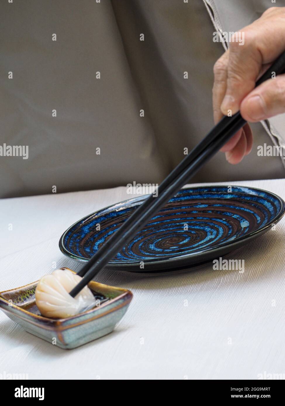 Chopsticks holding a dumpling hi-res stock photography and images - Alamy