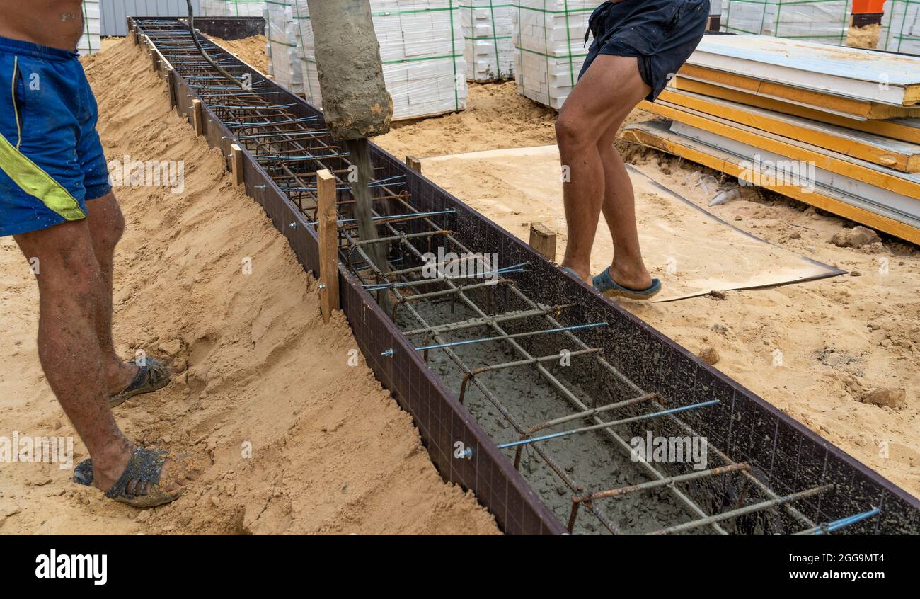 Pouring cement or concrete with automatic pump, construction site with ...
