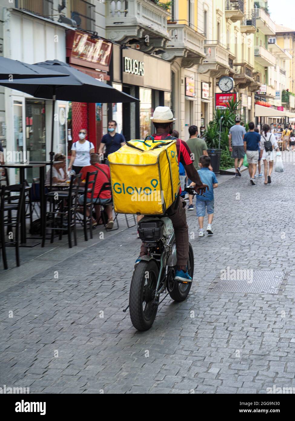 MILAN, ITALY - Aug 08, 2021: A rear view of a rider delivering food ...