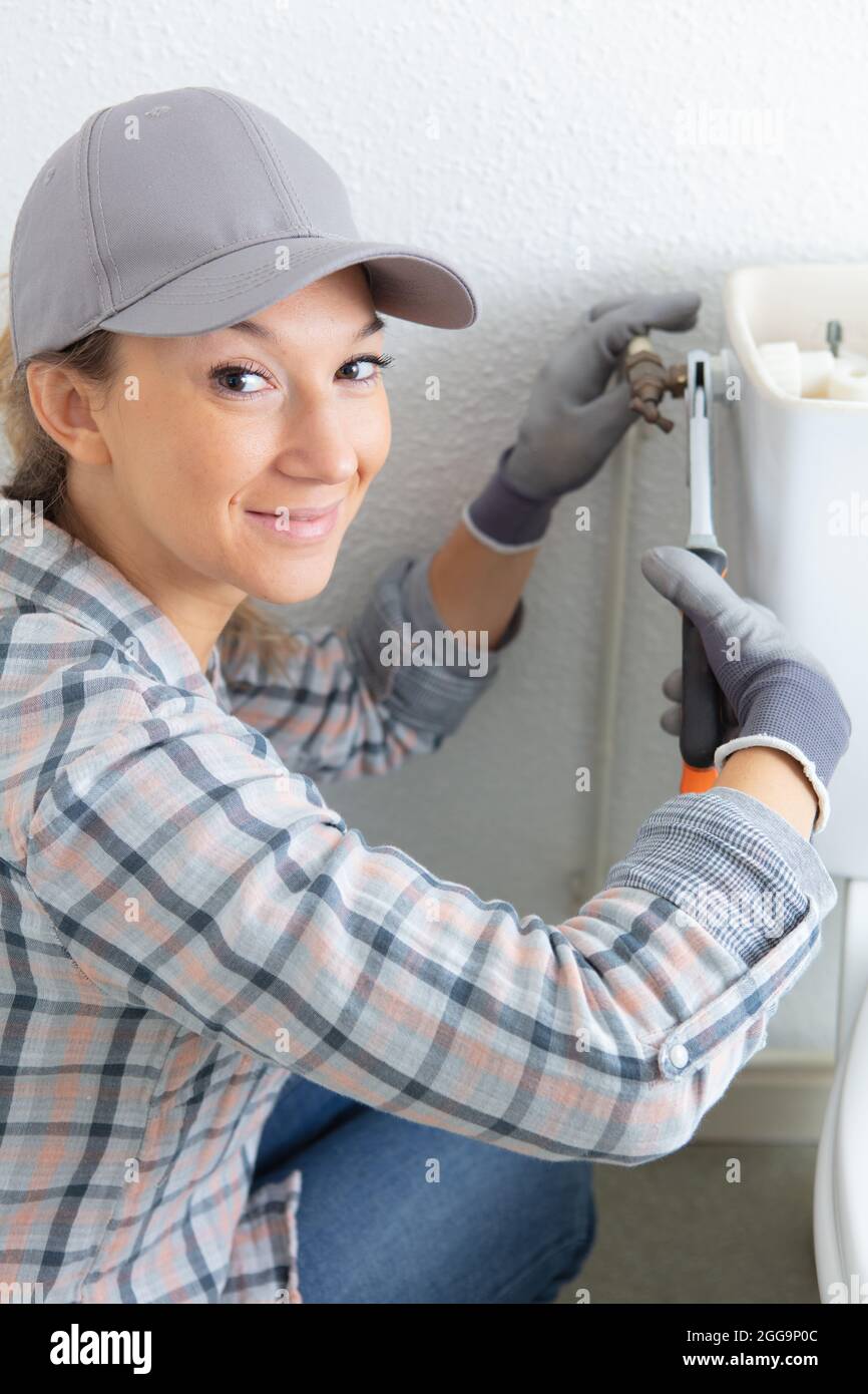 confident woman repairing toilets at clients home Stock Photo - Alamy