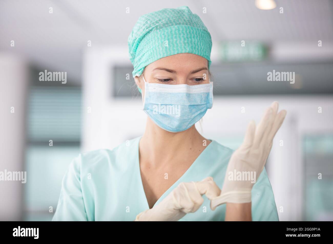 female surgeon wearing gloves before operation Stock Photo - Alamy