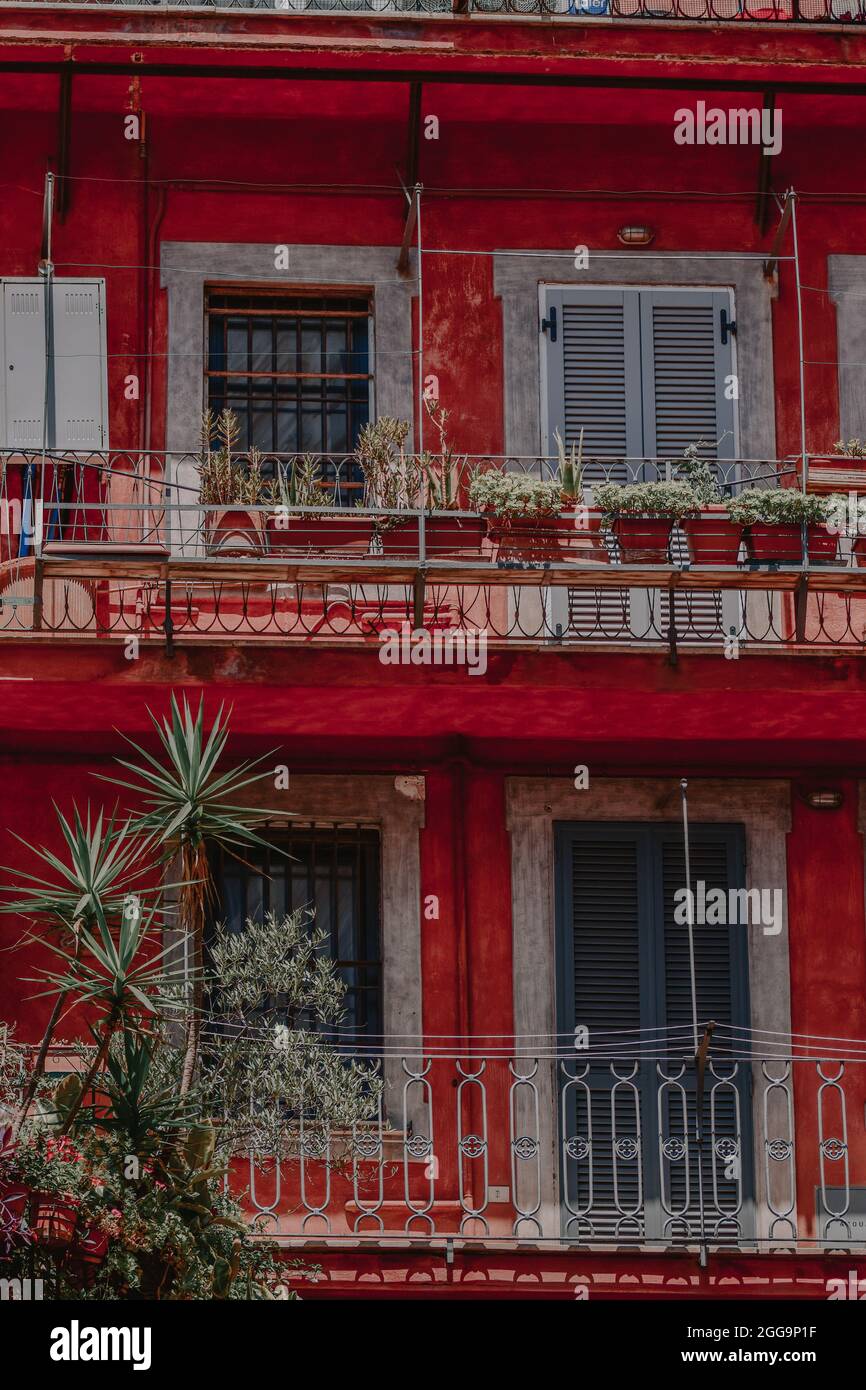 Vertical shot of red balconies in an Italian building in Rome, Italy ...