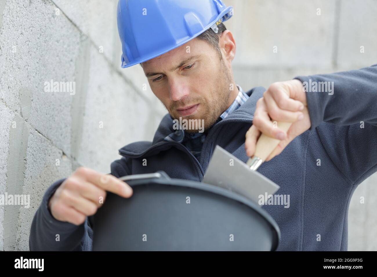 plaster inside bucket for wall renovation Stock Photo - Alamy