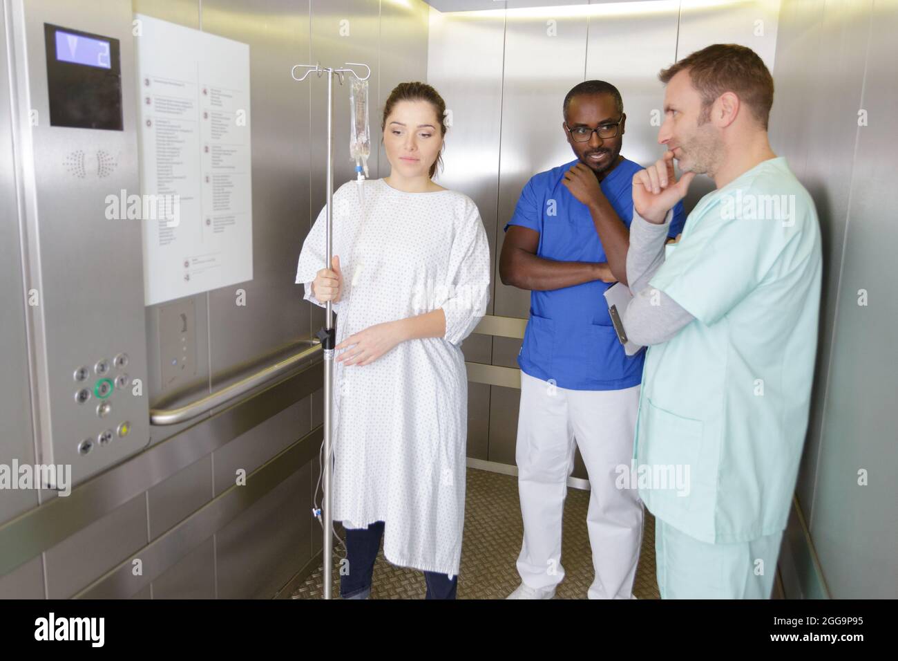 male doctors and female patient on elevator Stock Photo - Alamy