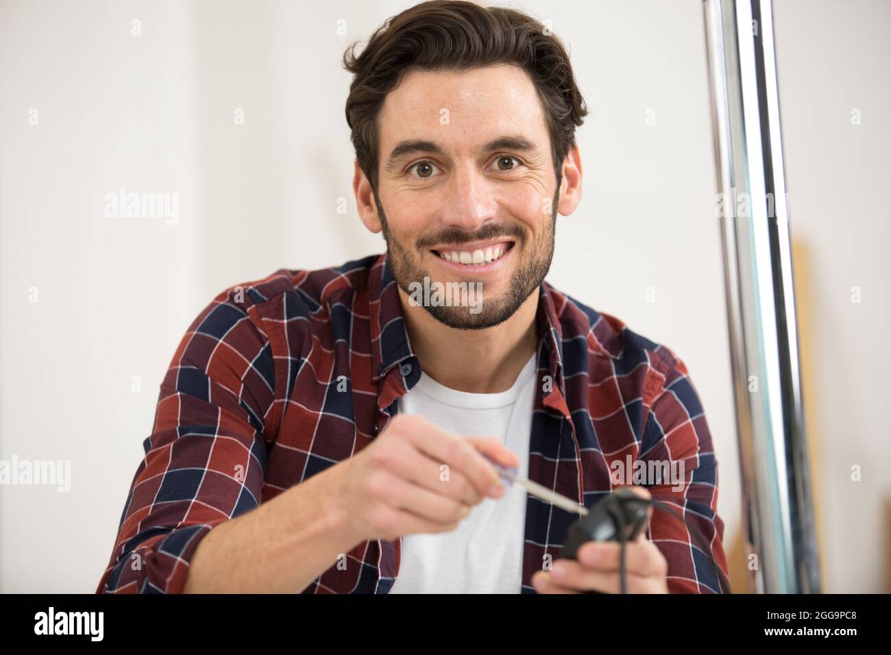 happy man is fixing a furniture at home Stock Photo - Alamy