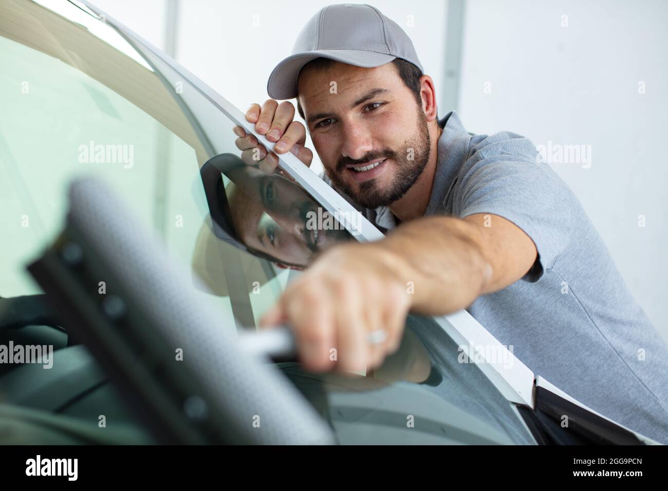 mature male worker cleaning car windshield Stock Photo - Alamy