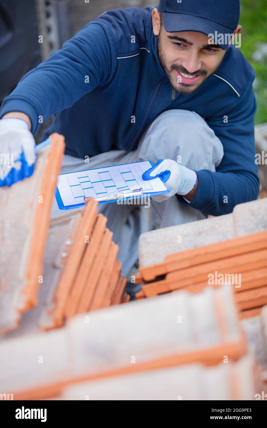 young man working as a bricklayer Stock Photo - Alamy