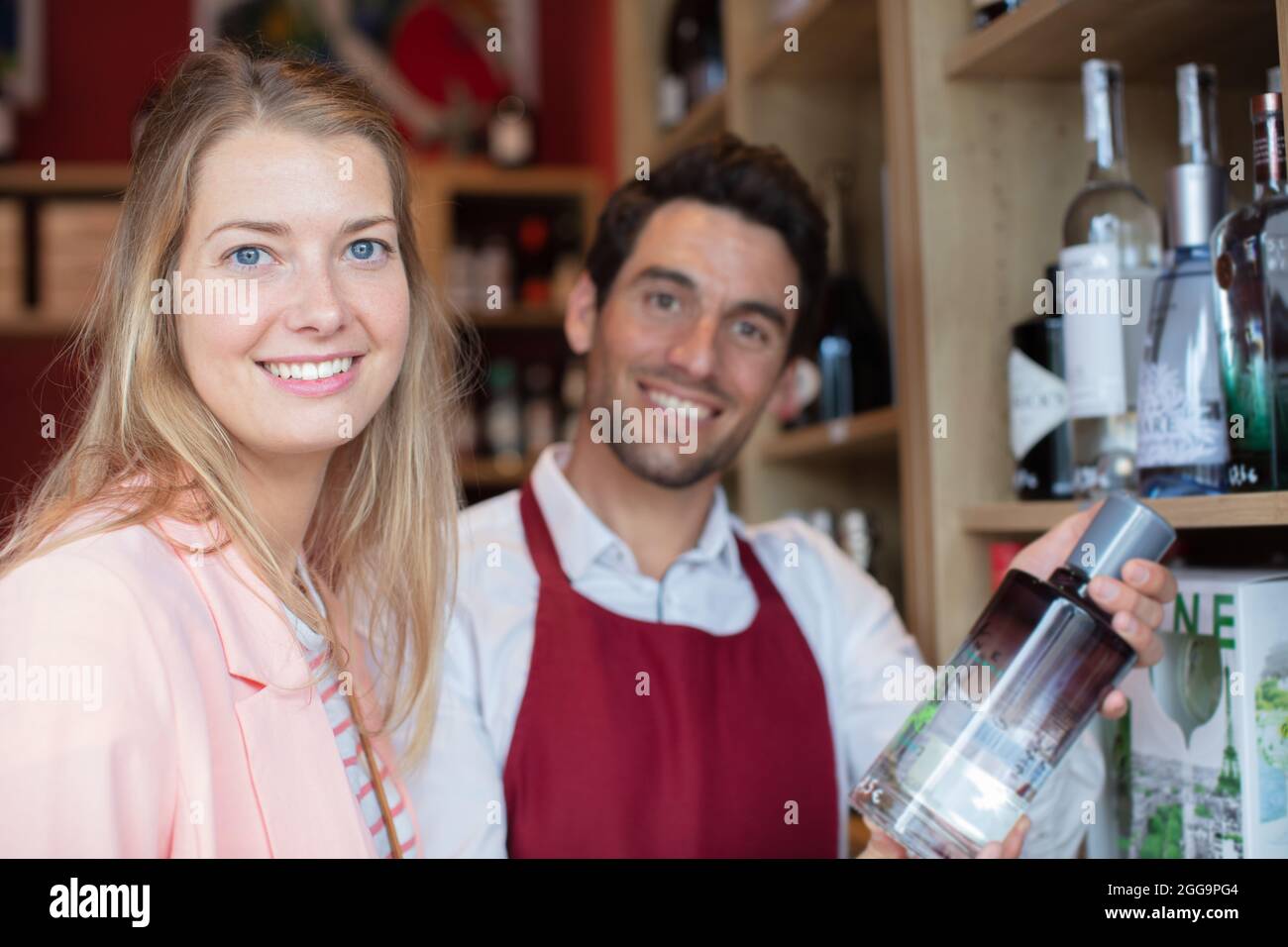 happy seller man smiling with female customer Stock Photo - Alamy