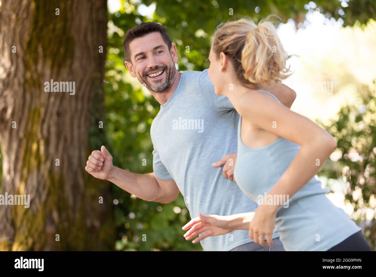 Sportive couple running in forest hi-res stock photography and images ...
